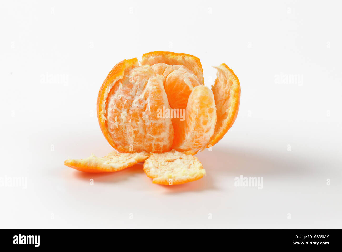 peeled ripe tangerine on white background Stock Photo - Alamy