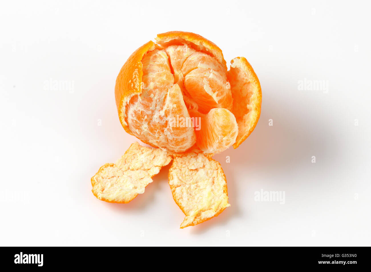 peeled ripe tangerine on white background Stock Photo - Alamy