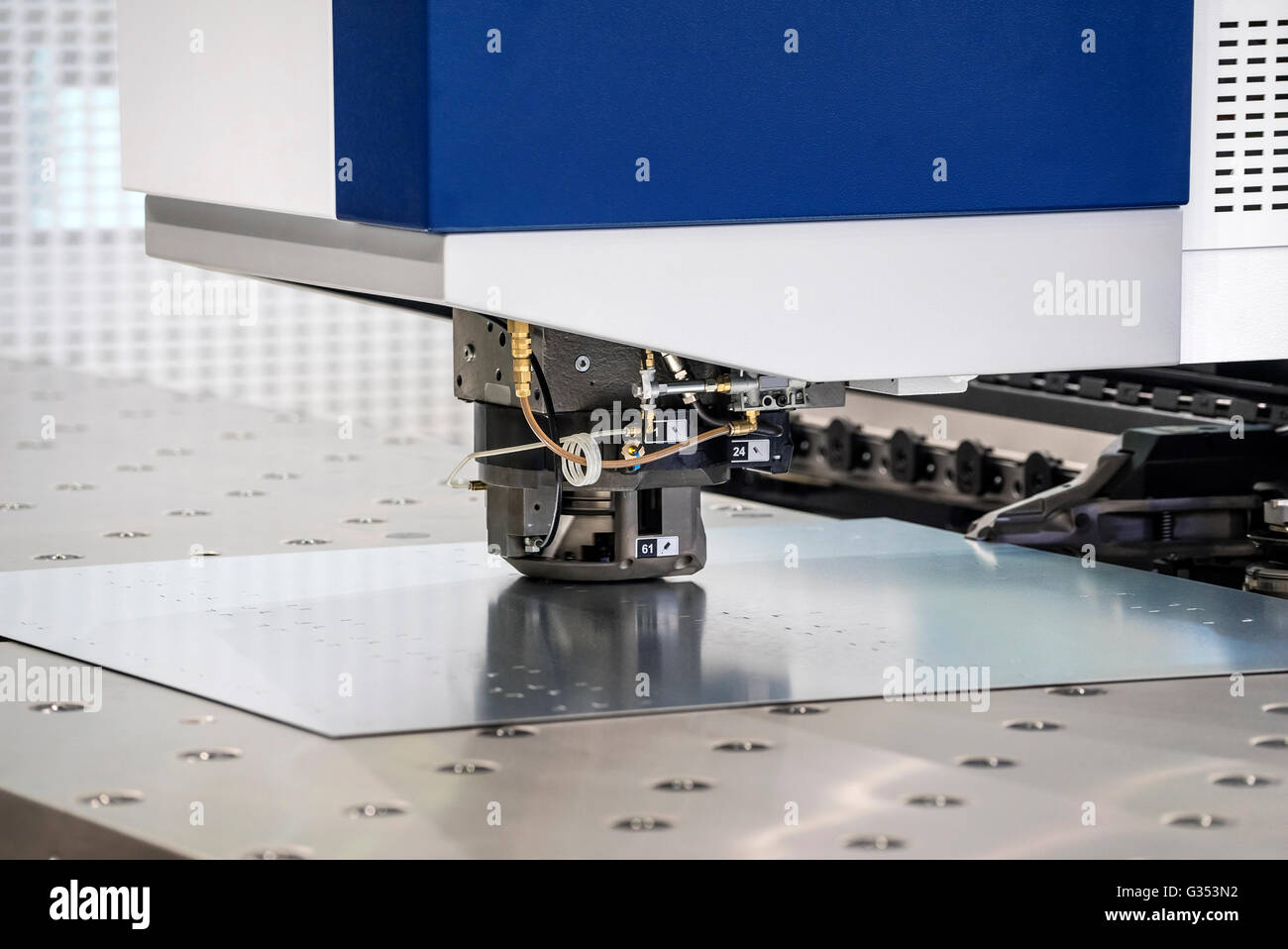 High-end machine for automatic punching metal sheet Stock Photo - Alamy