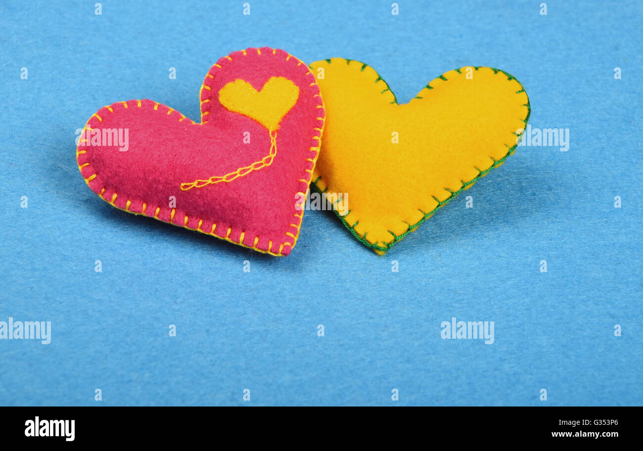 Felt craft and art, two handmade stitched toy hearts, pink and yellow ...