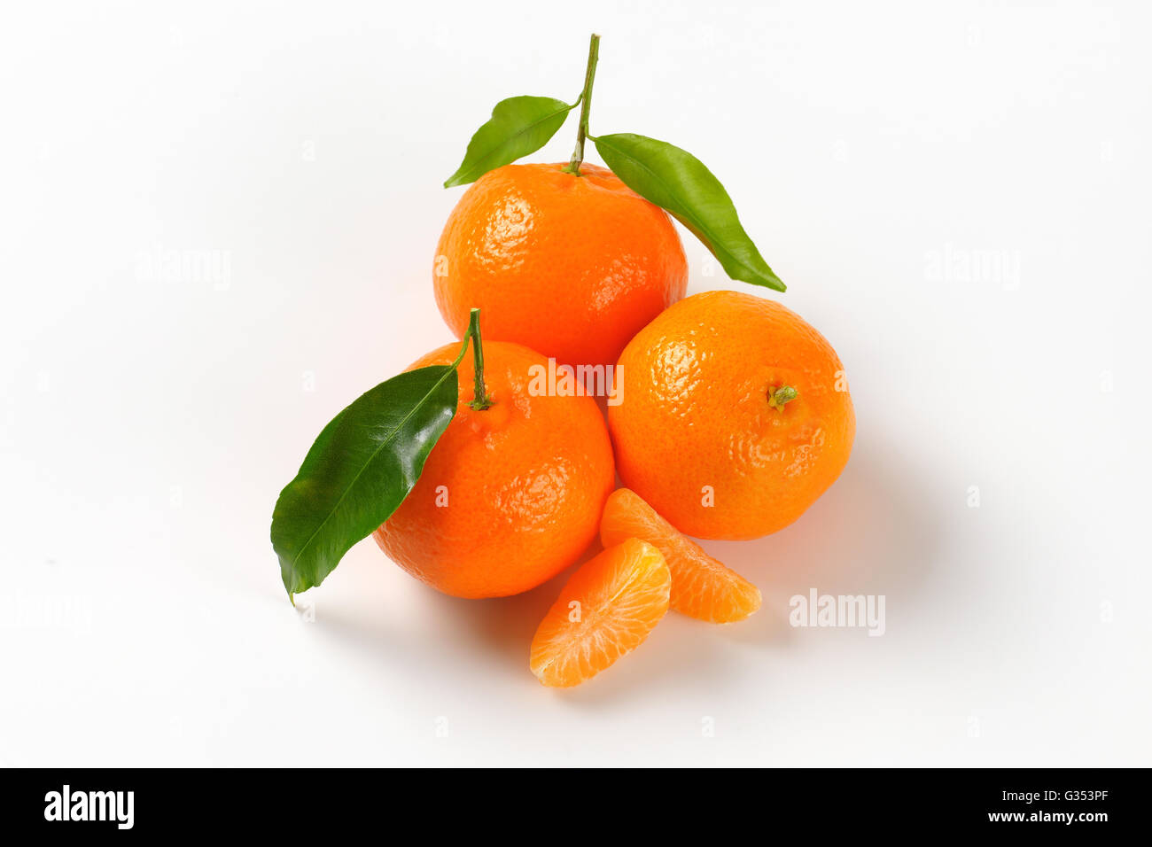 tangerines with separated segments on white background Stock Photo - Alamy