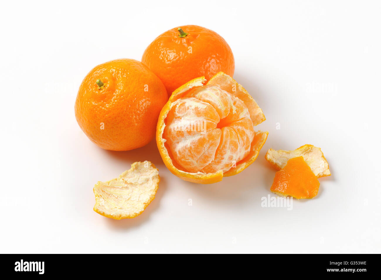 peeled and unpeeled tangerines on white background Stock Photo - Alamy