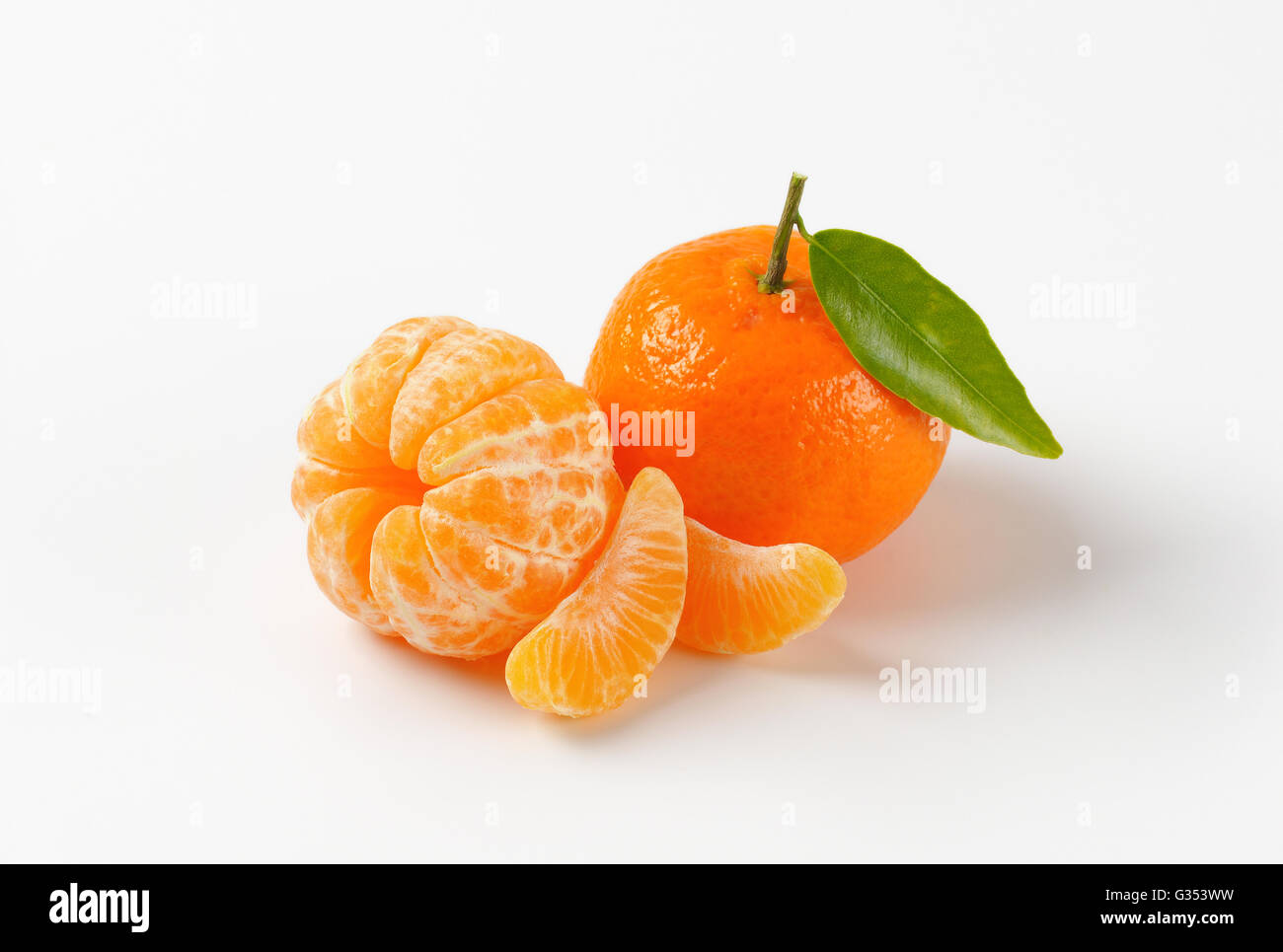 peeled and unpeeled tangerines on white background Stock Photo - Alamy