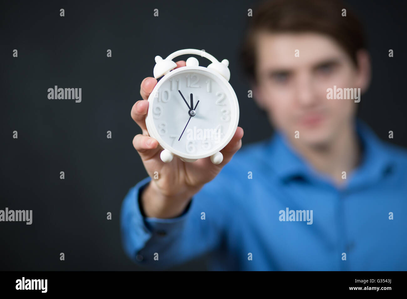 Successful businessman in formal wear pointing at clock Stock Photo - Alamy