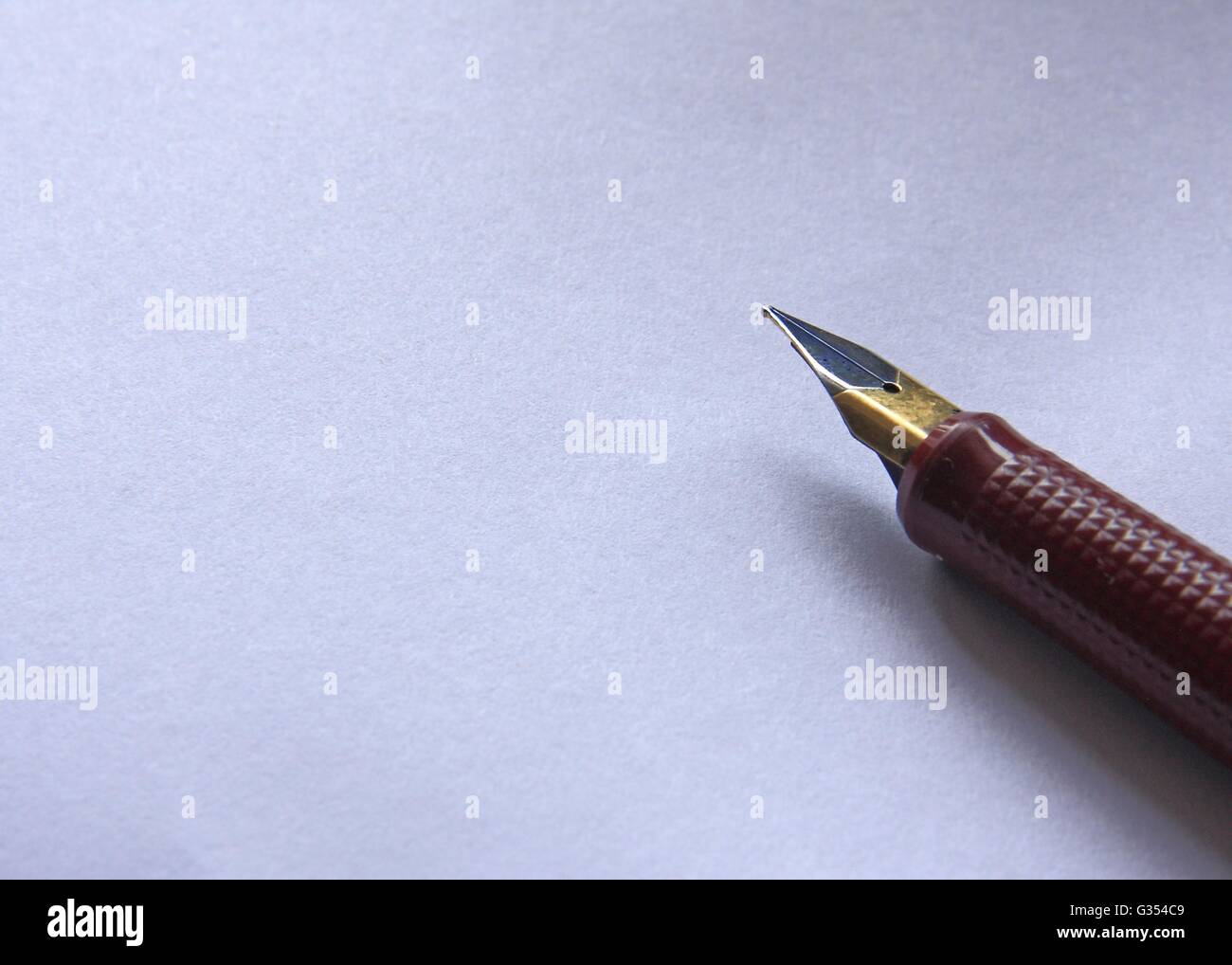 Pen on a white paper Stock Photo - Alamy