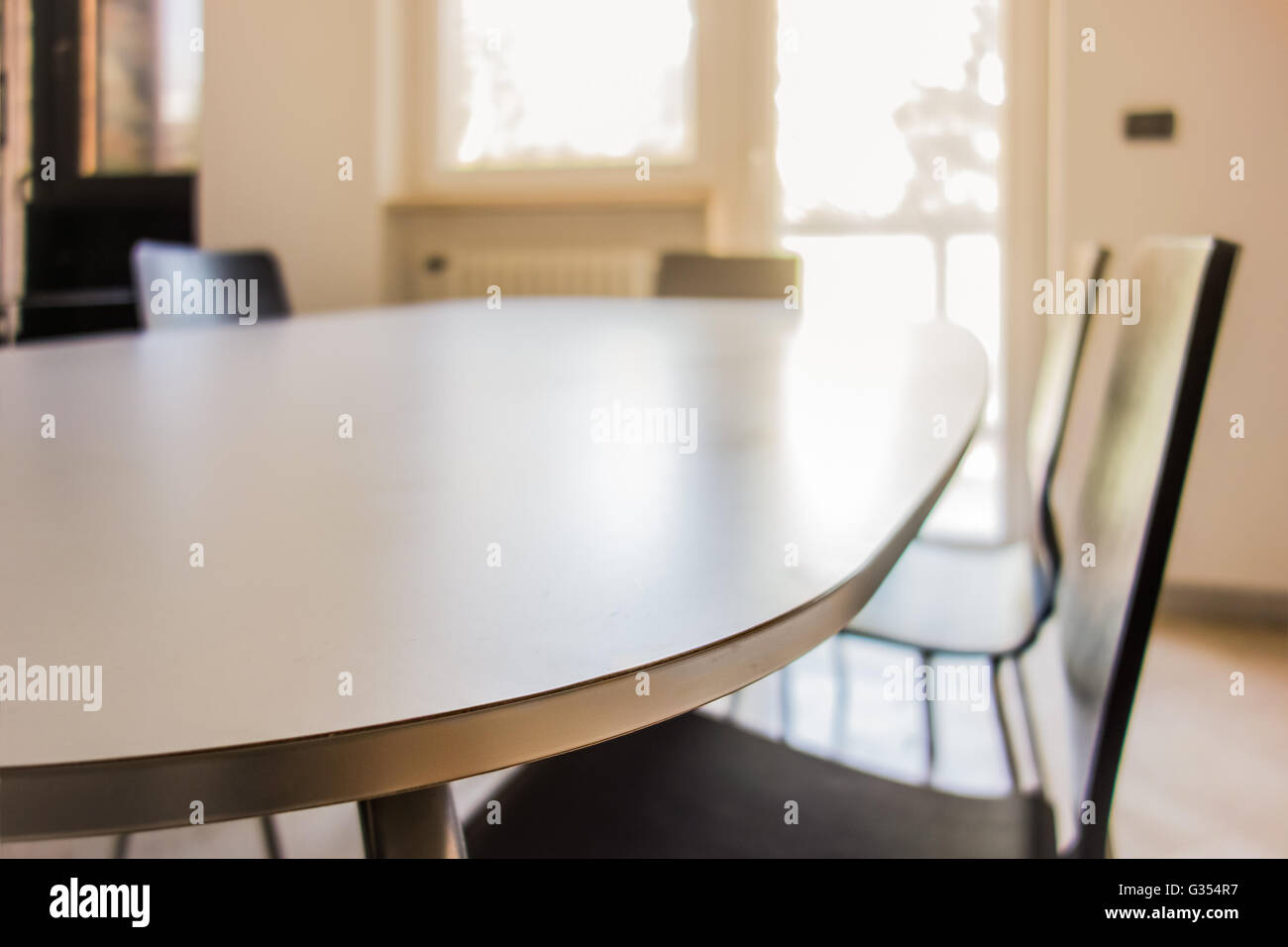 a conference or dining modern sleek table in a small room Stock Photo ...