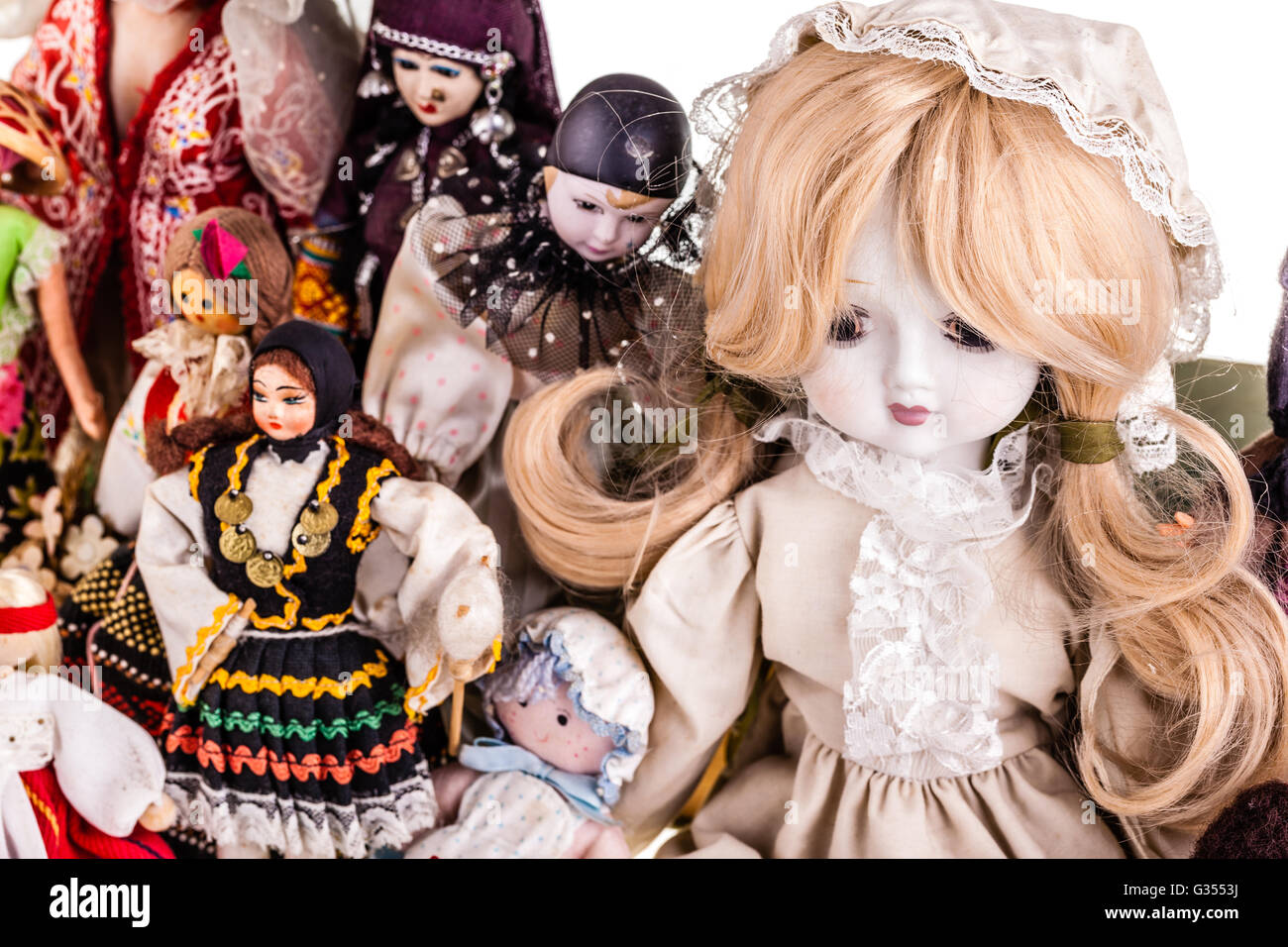a beautiful vintage dolls collection isolated over a white background ...