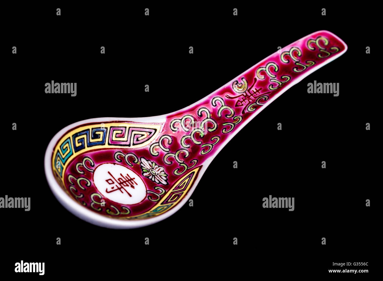 a chinese soup spoon isolated over a black background Stock Photo - Alamy
