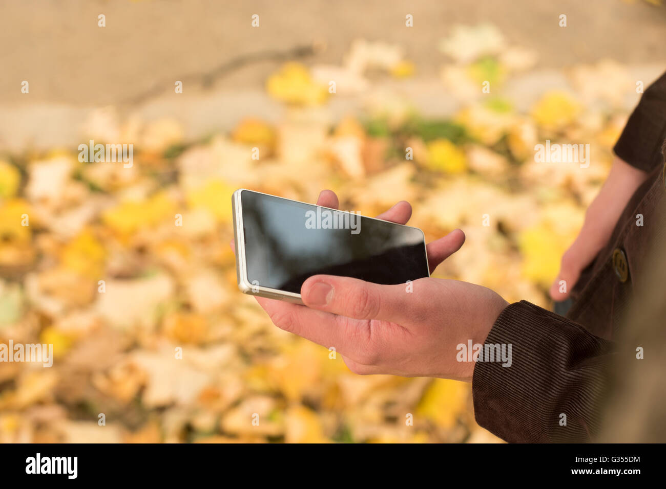 Man using cellphone outdoors Stock Photo - Alamy