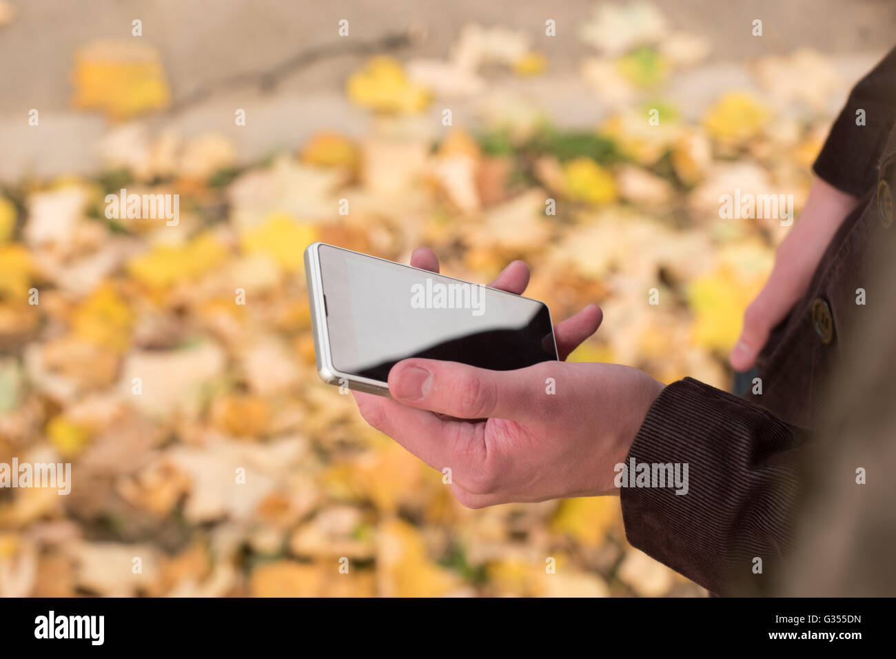 Man using cellphone outdoors Stock Photo - Alamy