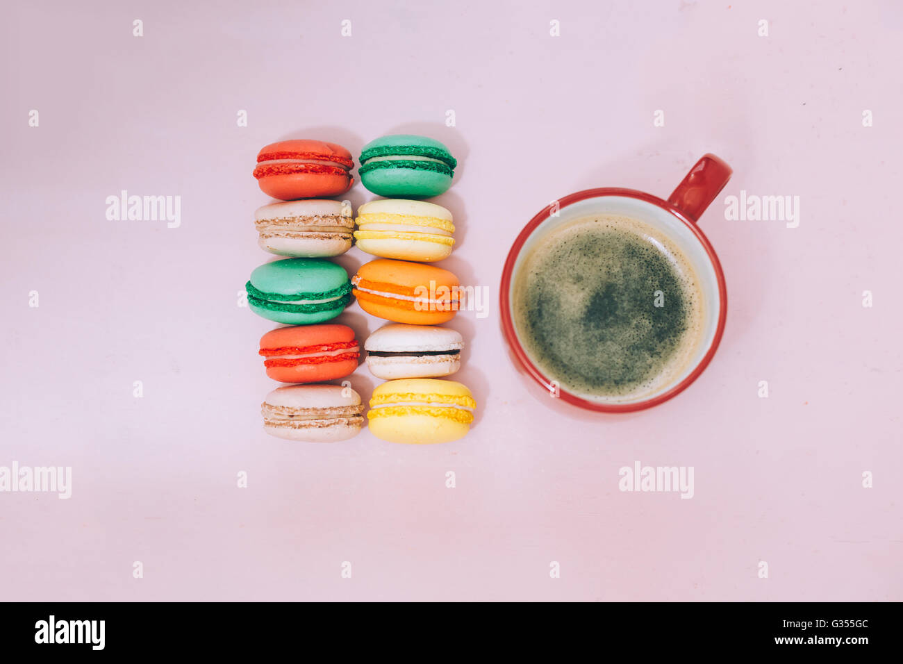 A cup of morning americano coffee with colorfull french macarons on a ...