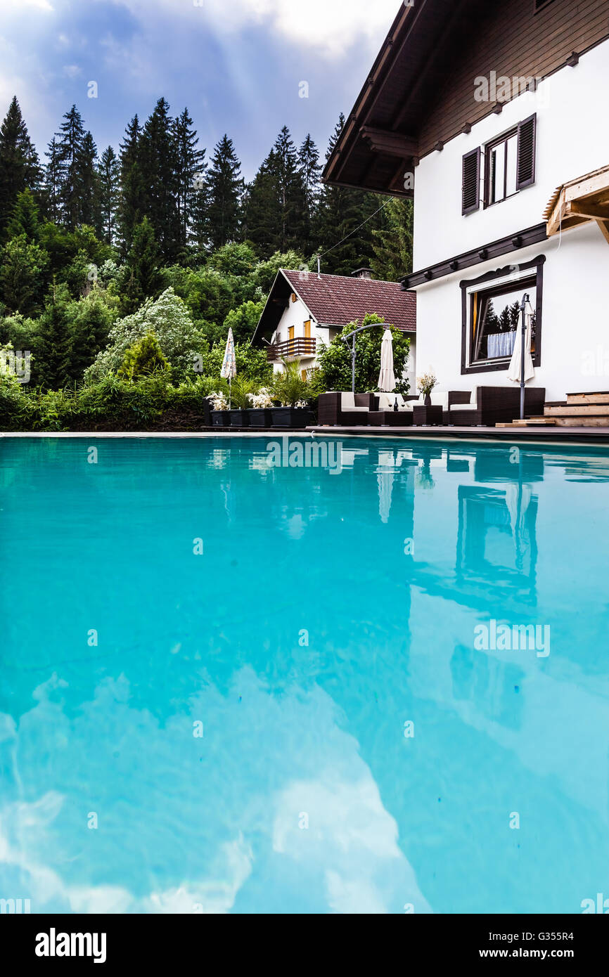 a luxurious lounge on the poolside of a beautiful big pool Stock Photo ...