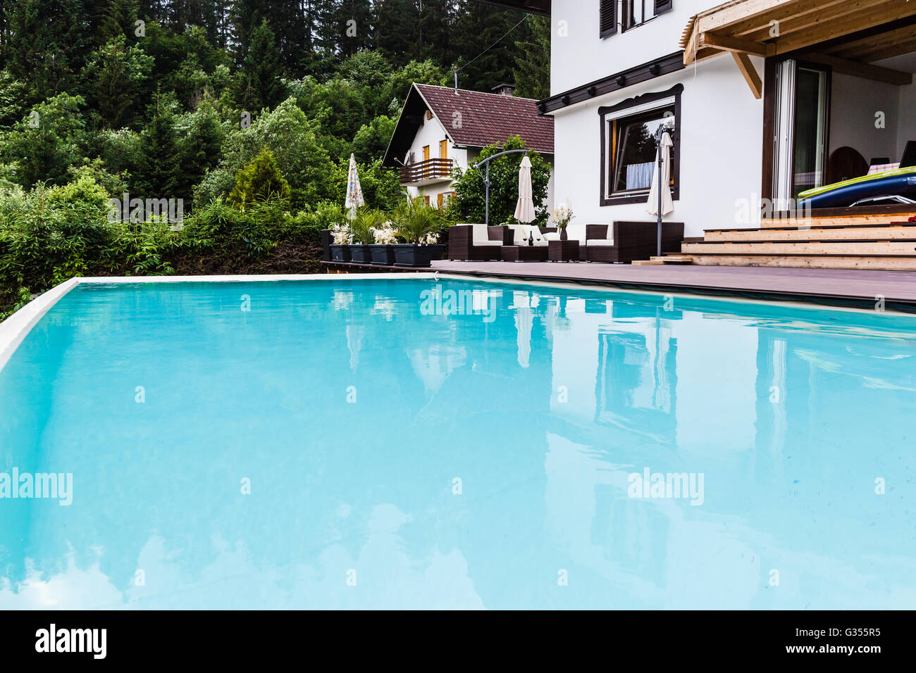 a luxurious lounge on the poolside of a beautiful big pool Stock Photo ...
