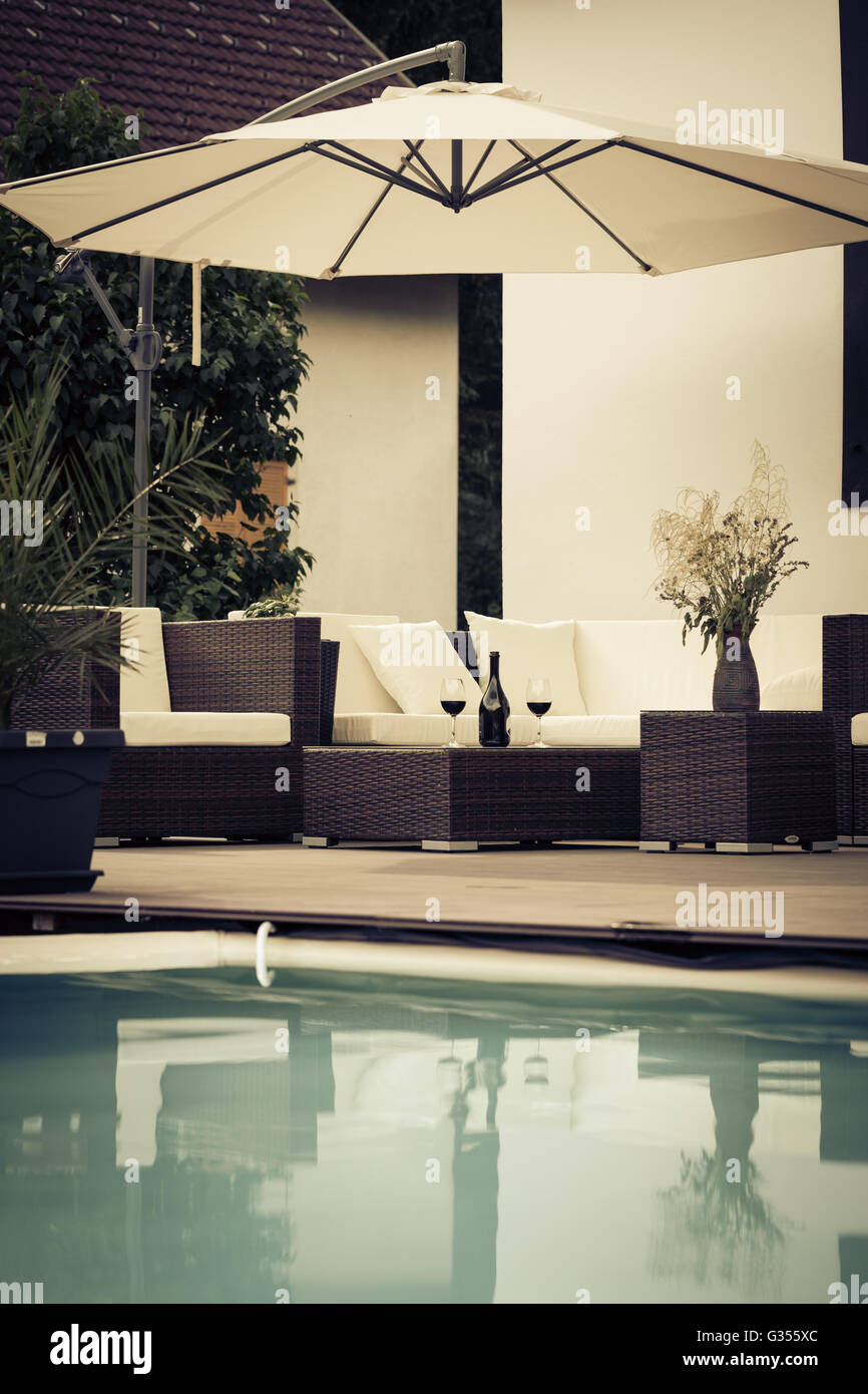 a luxurious lounge on the poolside of a beautiful big pool Stock Photo ...