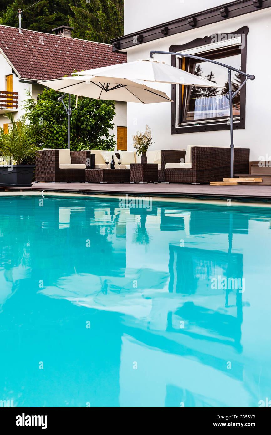 a luxurious lounge on the poolside of a beautiful big pool Stock Photo ...