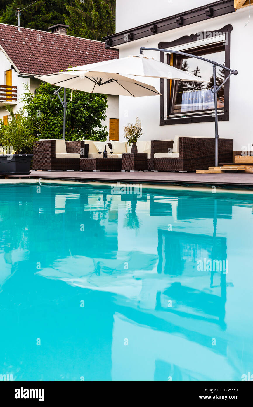 a luxurious lounge on the poolside of a beautiful big pool Stock Photo ...