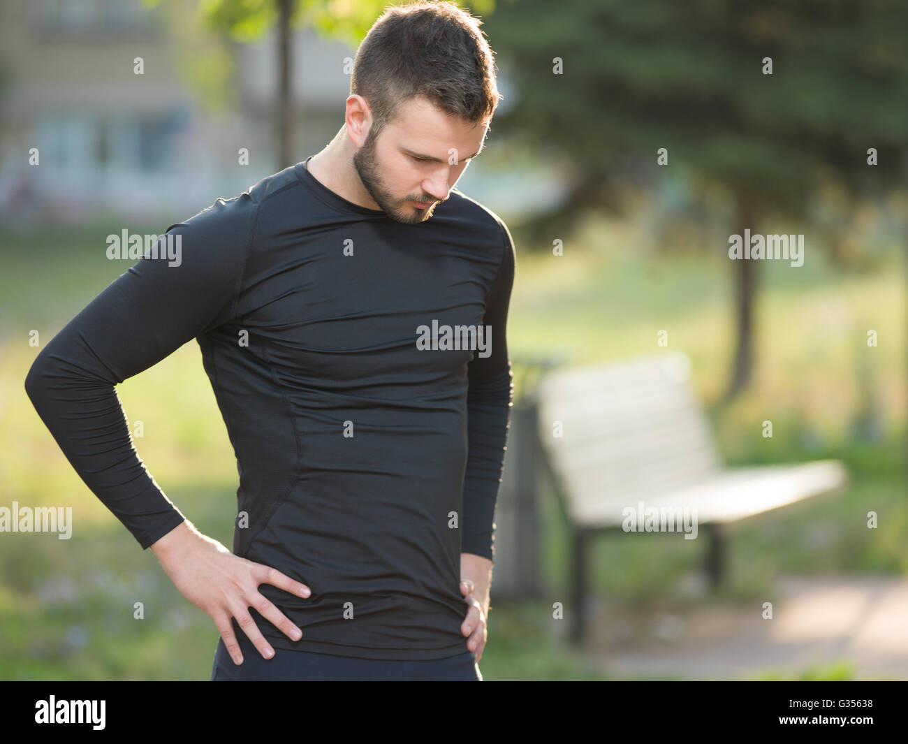 Portrait of Sport and fitness runner man resting on bridge after ...