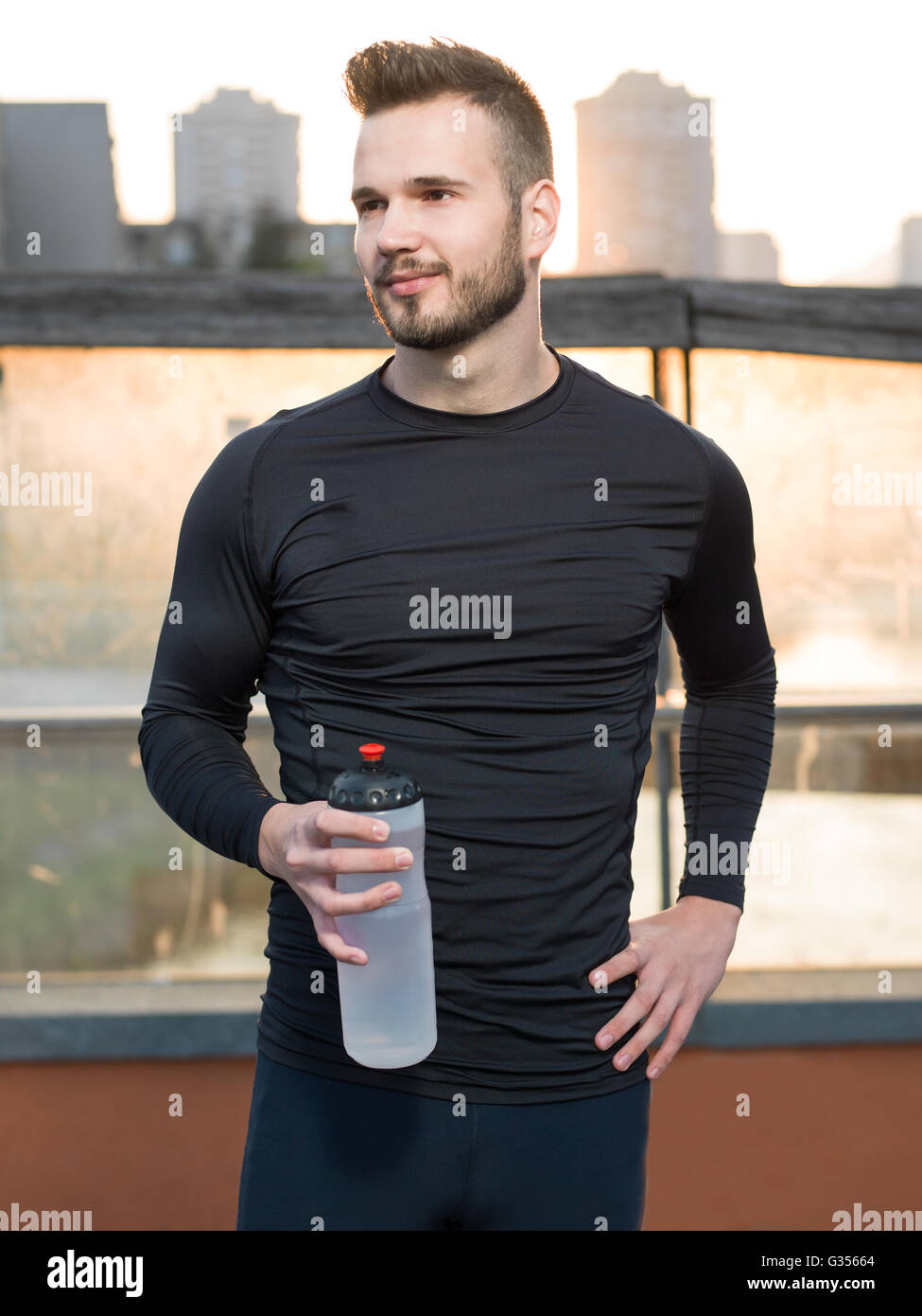 Athletic Handsome Man in Black Workout Clothing Running at the River ...