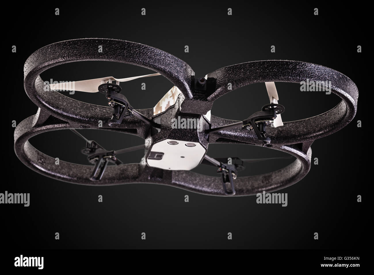 a small spy quad copter drone flying over a dark background Stock Photo ...