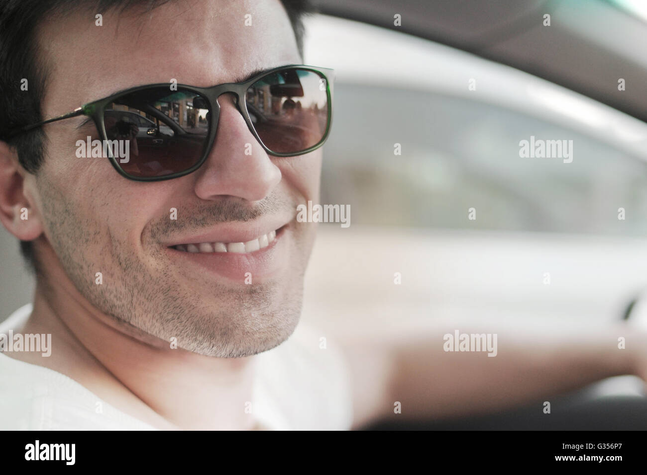 side view of a young man driving his convertible car Stock Photo - Alamy
