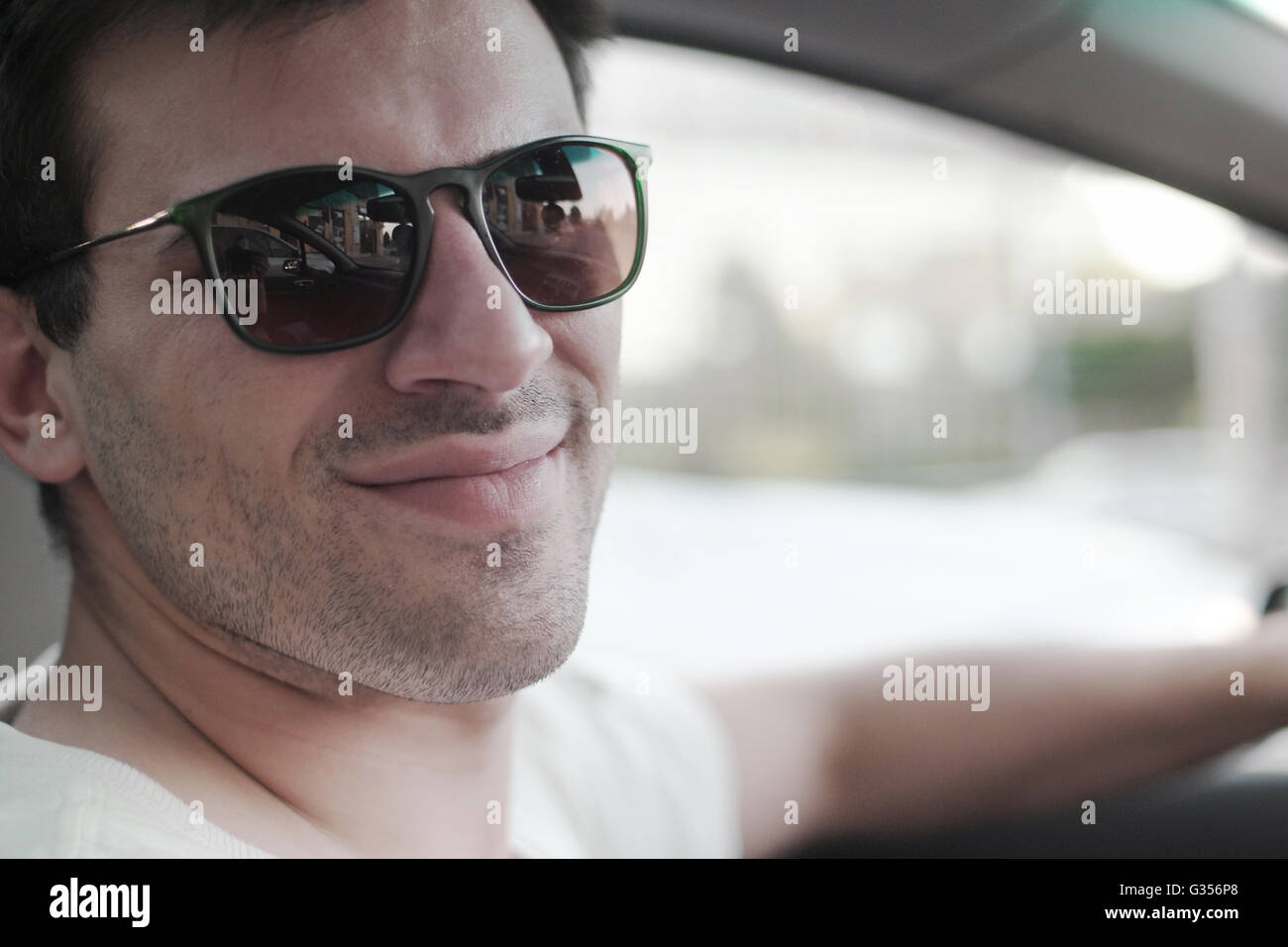 side view of a young man driving his convertible car Stock Photo - Alamy