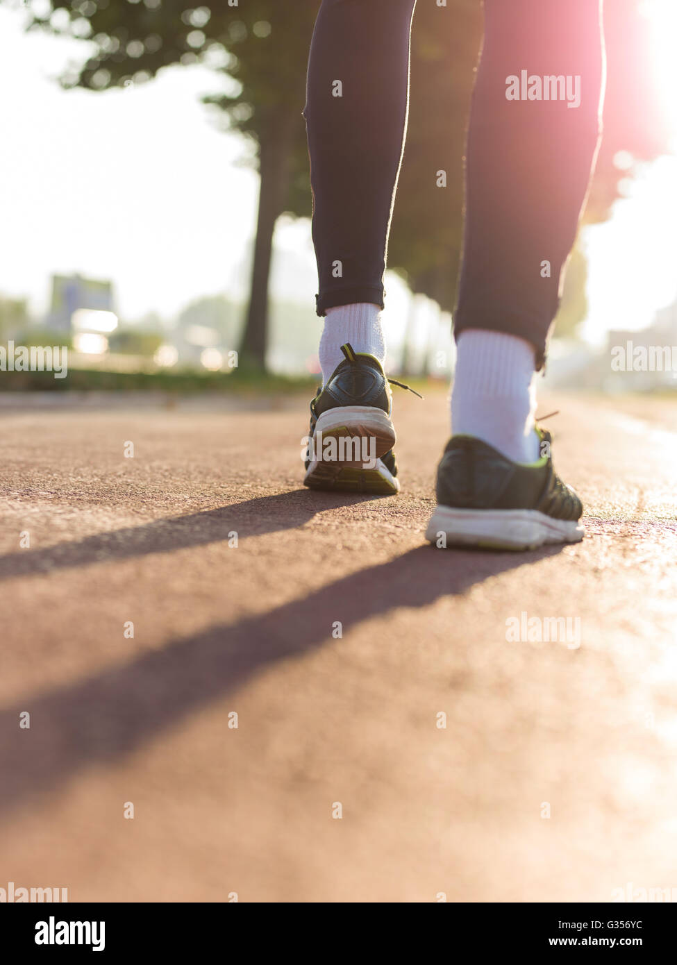 Running shoes, feet and legs close up of runner jogging in action and ...