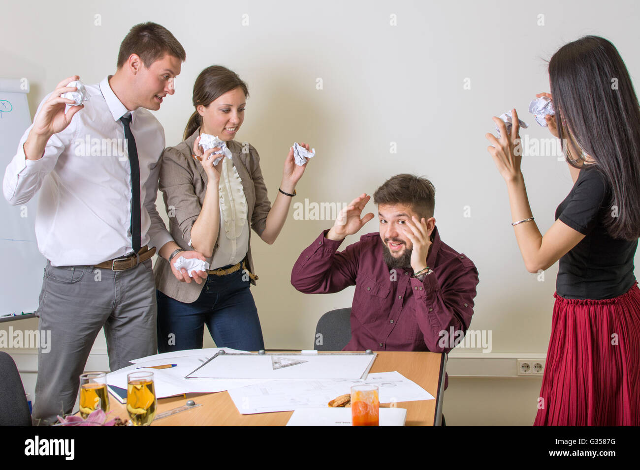 People throwing papers on a colleague at the office Stock Photo - Alamy