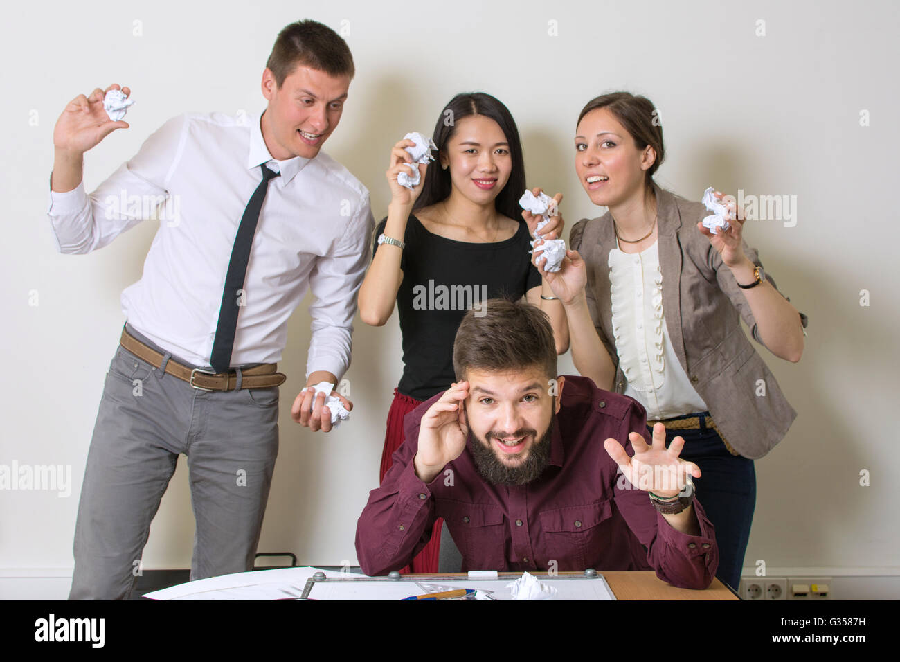 People throwing papers on a colleague at the office Stock Photo - Alamy