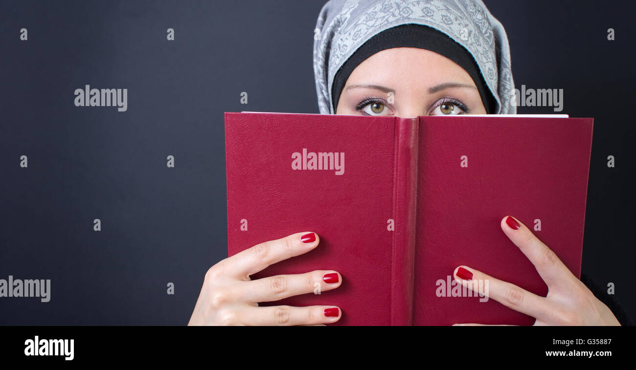 Muslim girl reading book hi-res stock photography and images - Alamy