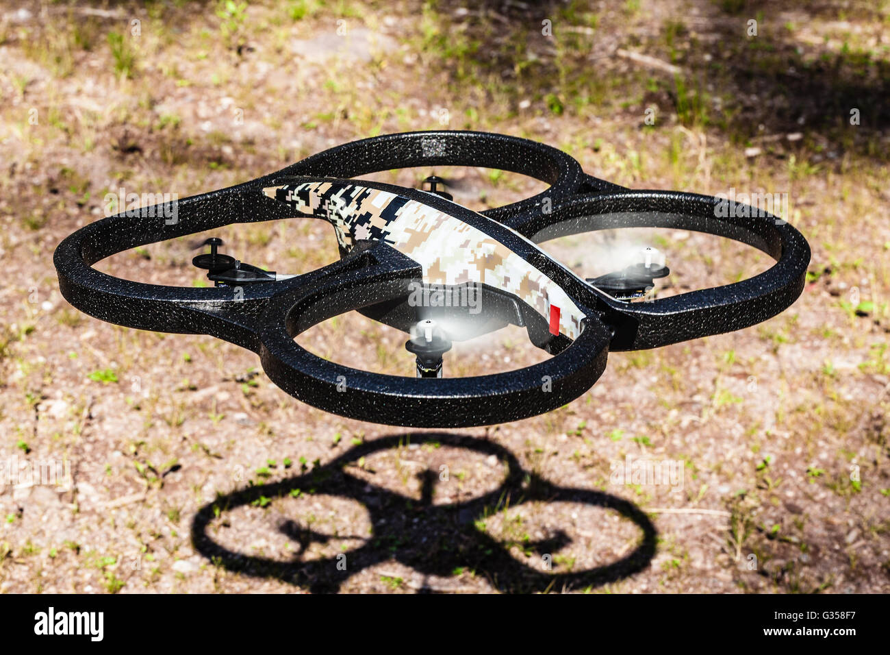 a small spy quad copter drone with a camouflage hull taking off Stock ...