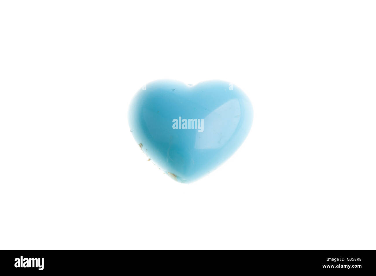 a small turquoise heart shaped pendant isolated over a white background ...