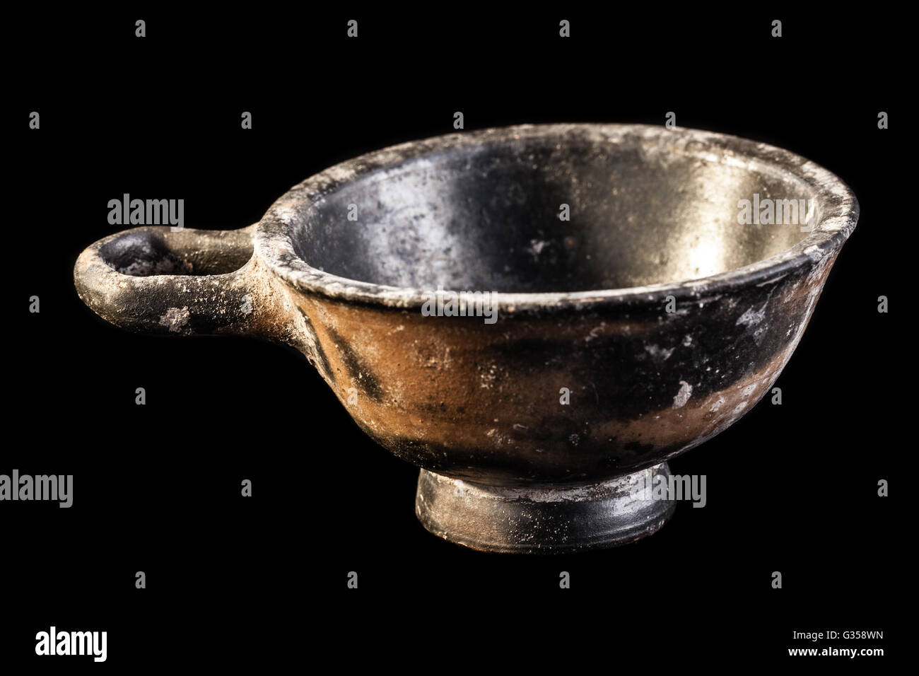 Apulian black pottery ancient canosan bowl isolated over a dark ...