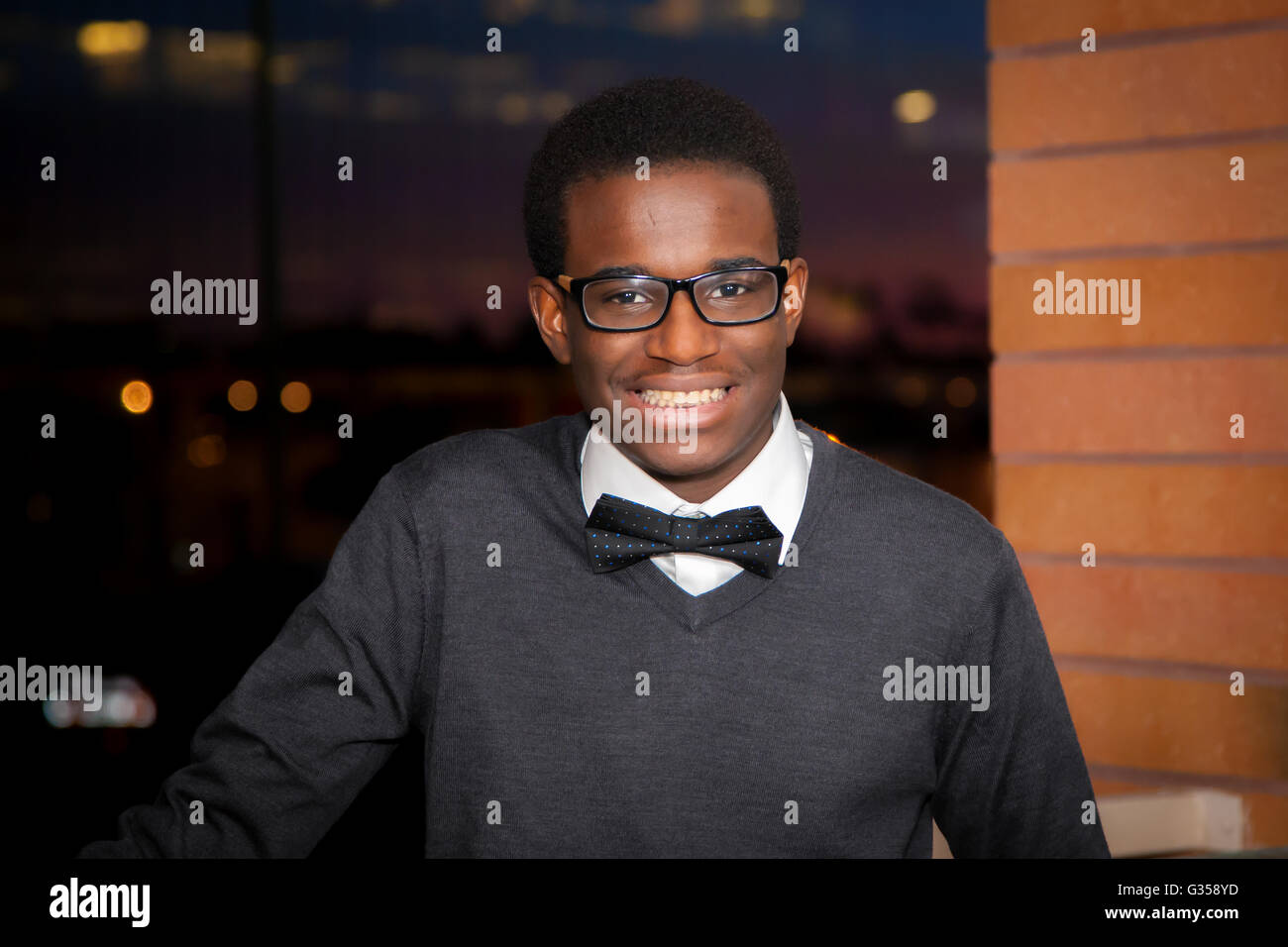 A teenage african american boy wearing a bowtie smiles for the camera ...