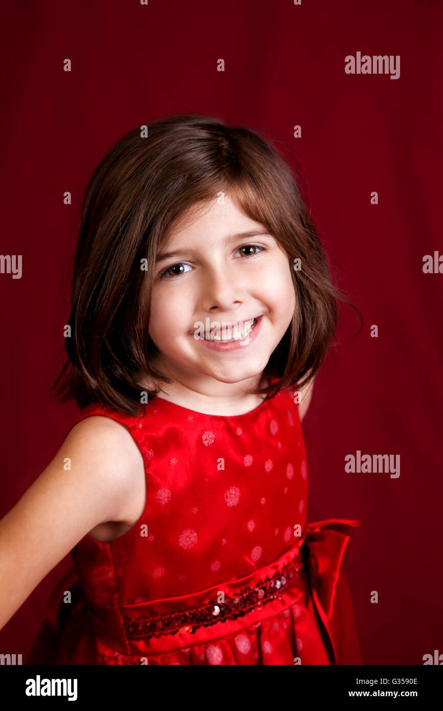Portrait of a cute little girl on red Stock Photo - Alamy