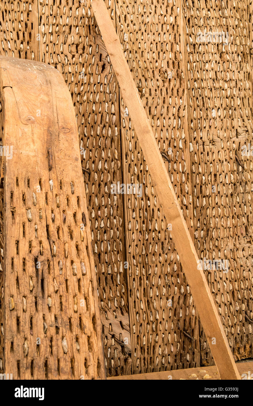 Vintage thresher made of wood and flint stone Stock Photo - Alamy