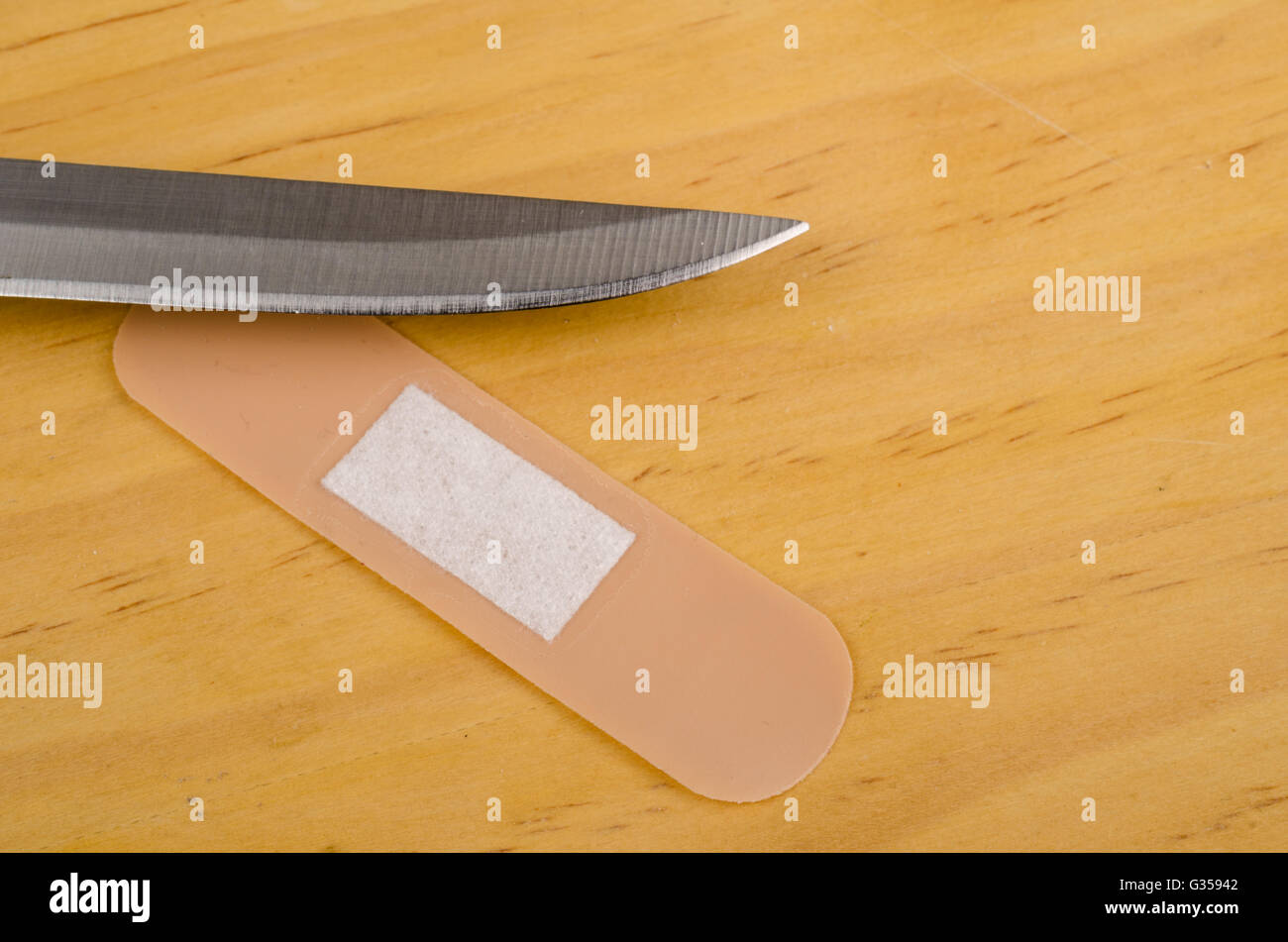 Kitchen knife and band aid, domestic accident concept Stock Photo - Alamy