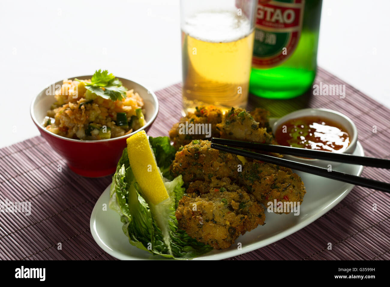 A traditional serving of Thai Fish Cakes (tod man pla) presented with ...