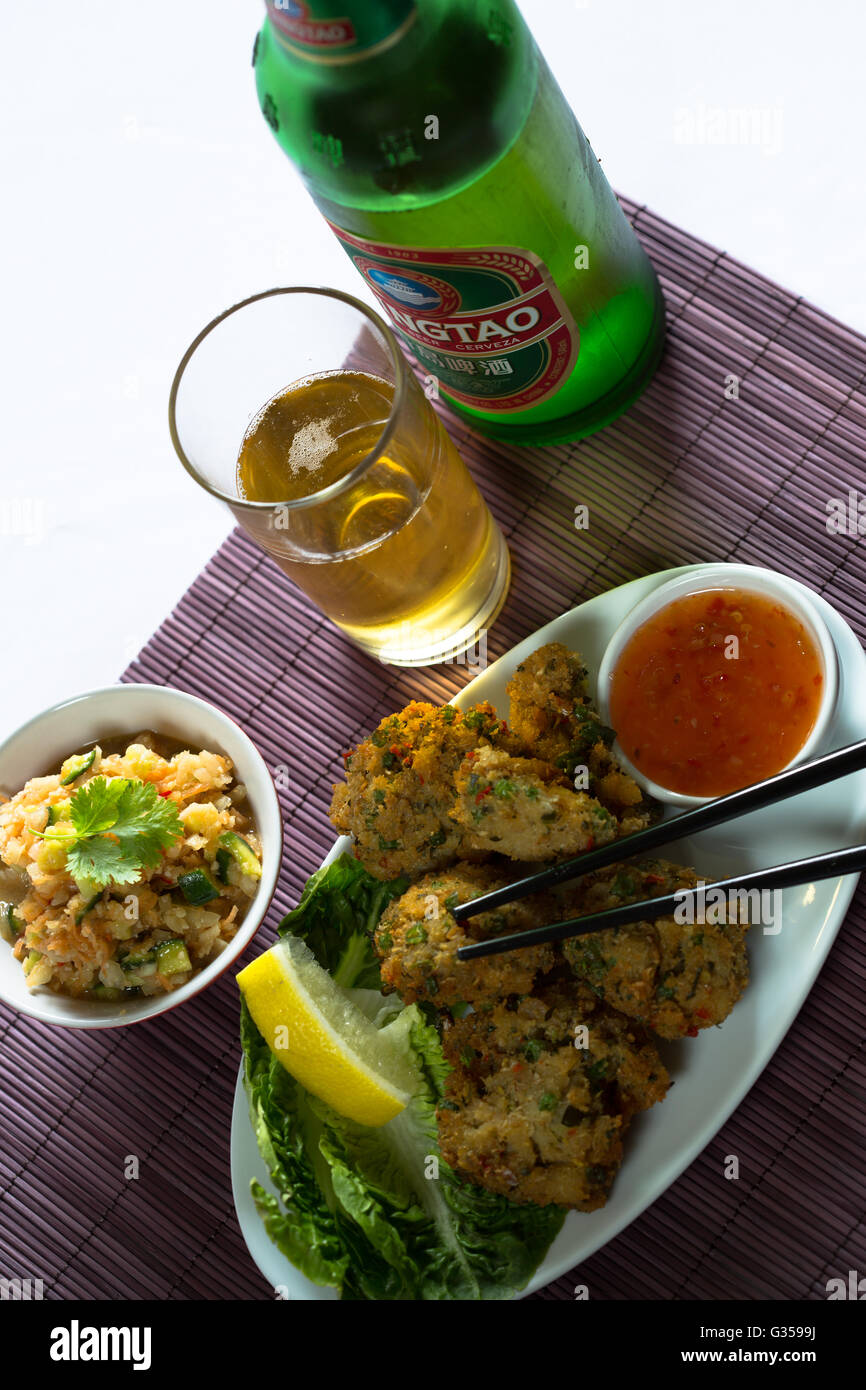 A traditional serving of Thai Fish Cakes (tod man pla) presented with ...