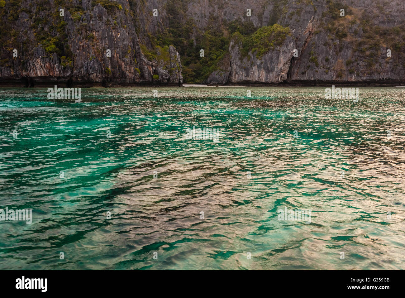 Maya Bay is sheltered by high cliffs on three sides with several ...
