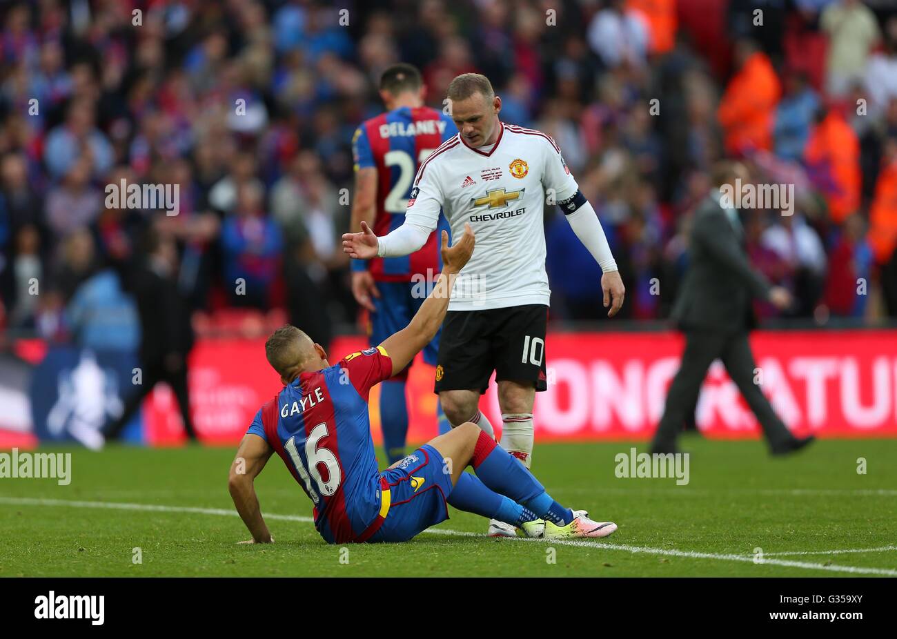 Wayne Rooney of Manchester United helps Crystal Palace’s Dwight Gayle ...