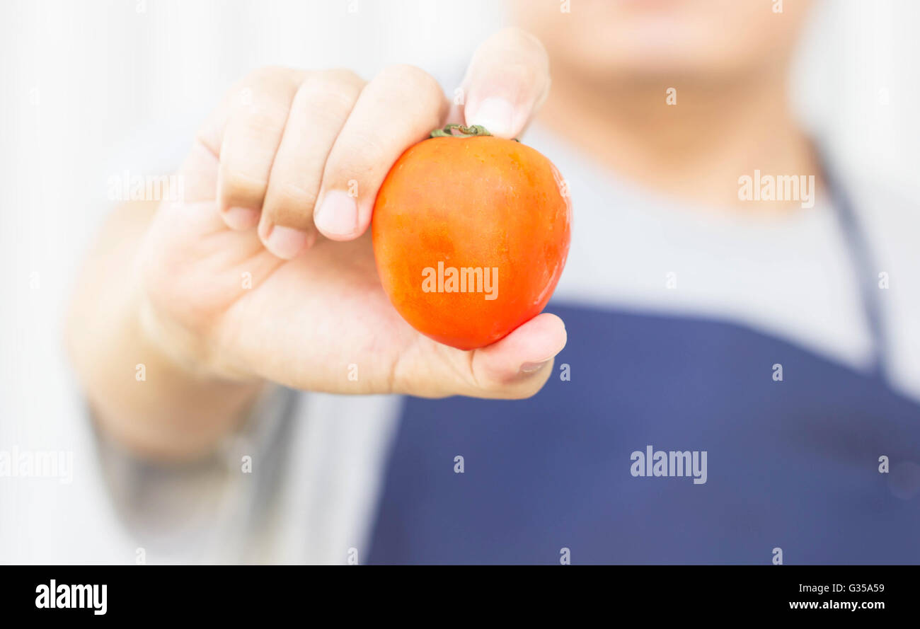 Red tomato in hand hi-res stock photography and images - Alamy