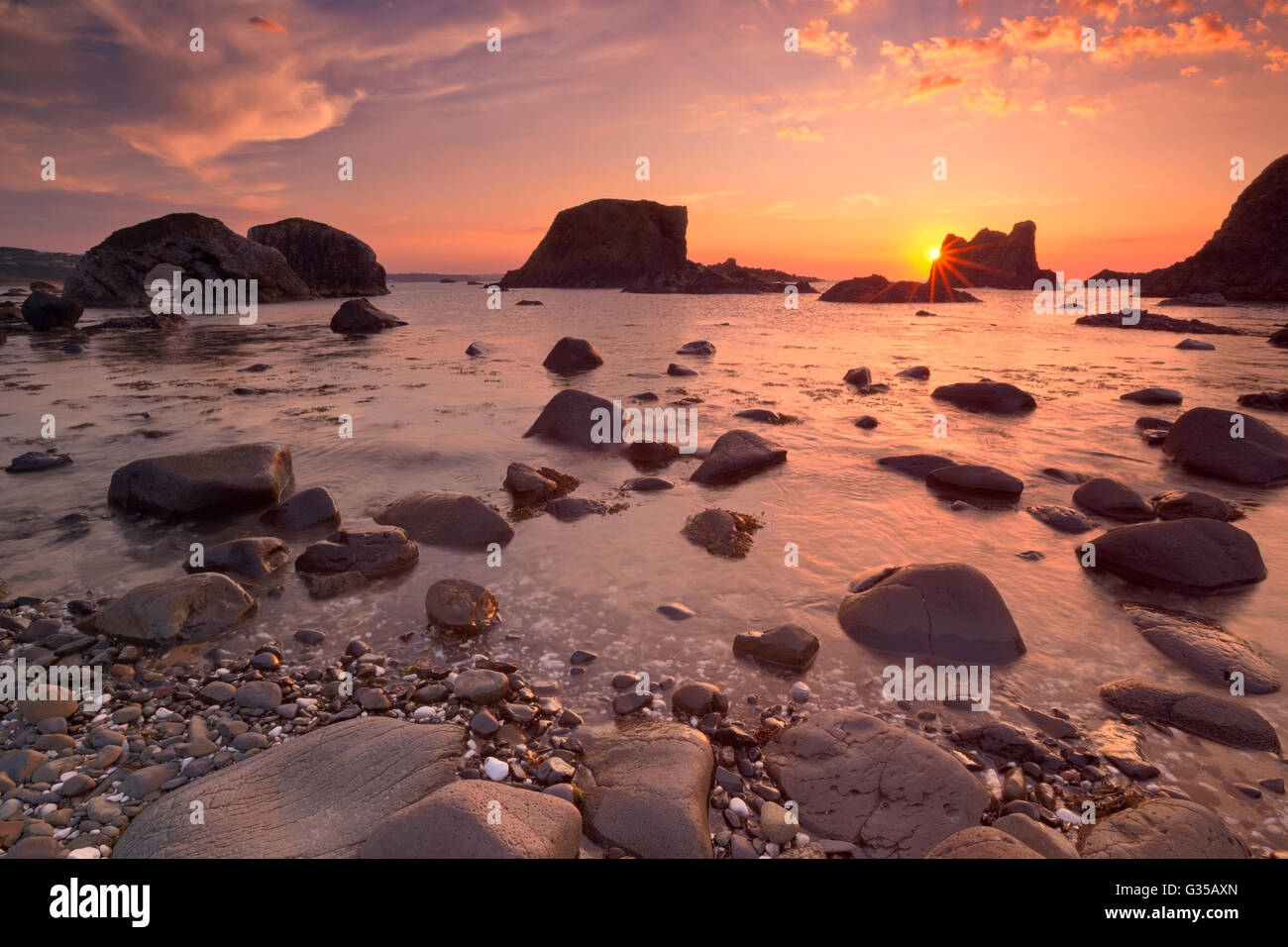 Sea stacks and natural arch along the coast near Ballintoy Harbour on ...