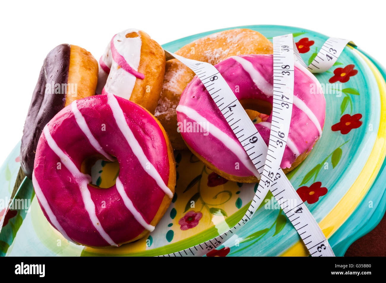 some delicious and colorful donuts with measuring tape Stock Photo - Alamy