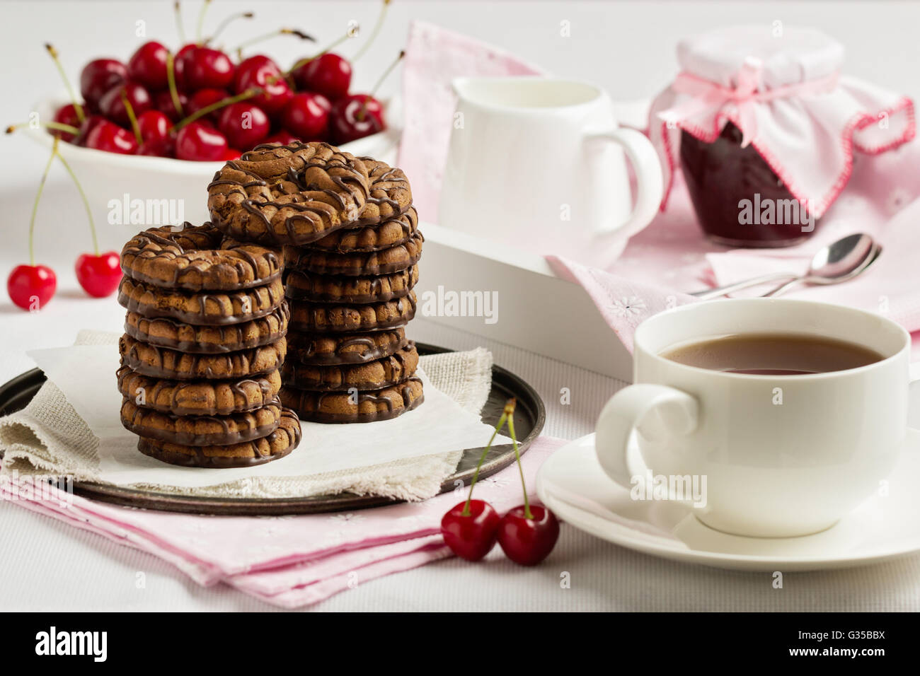 Breakfast. Tea with chocolate chip cookies on a white tray. Selective ...