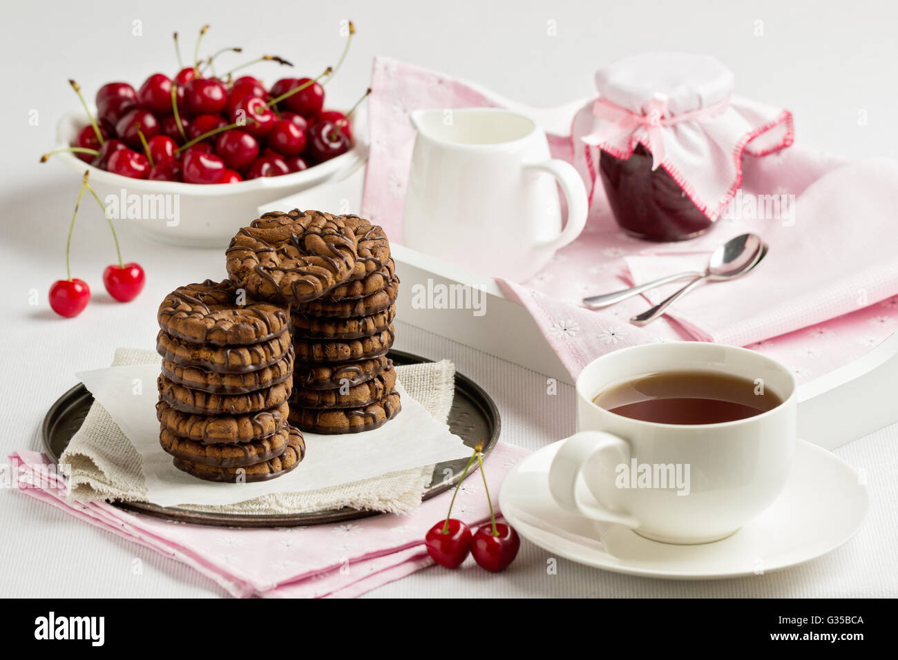 Breakfast. Tea with chocolate chip cookies on a white tray. Selective ...