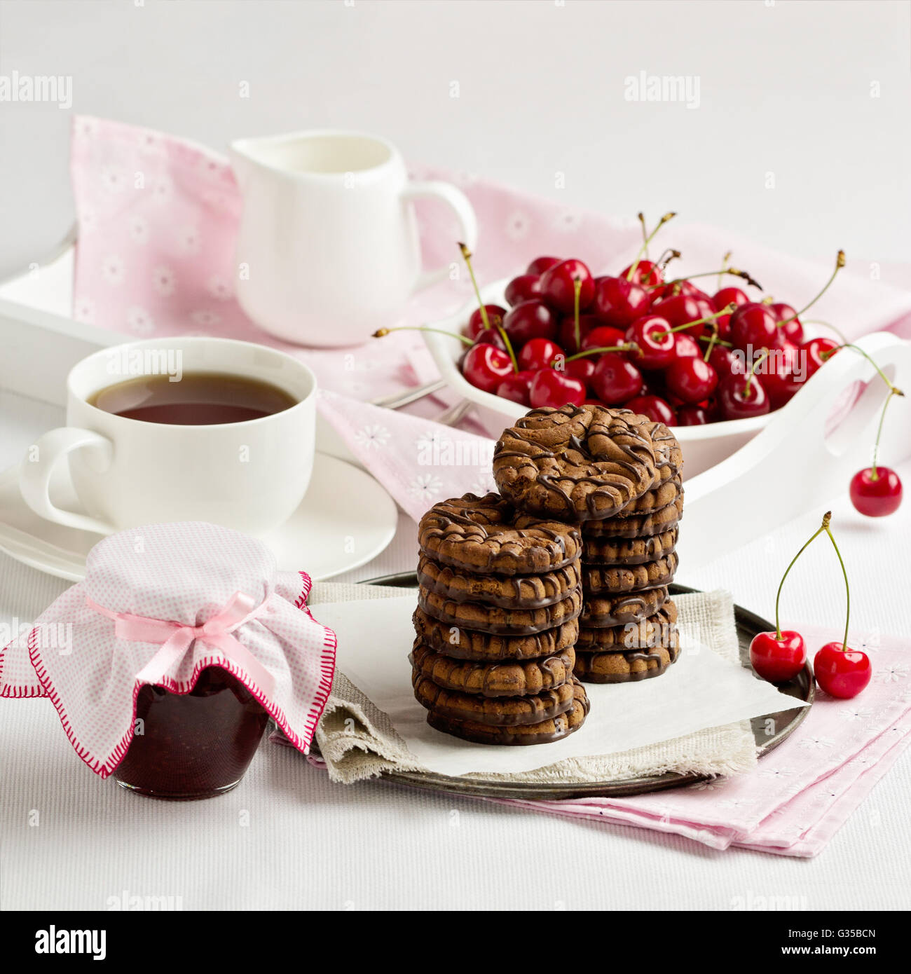 Breakfast. Tea with chocolate chip cookies on a white tray. Selective ...
