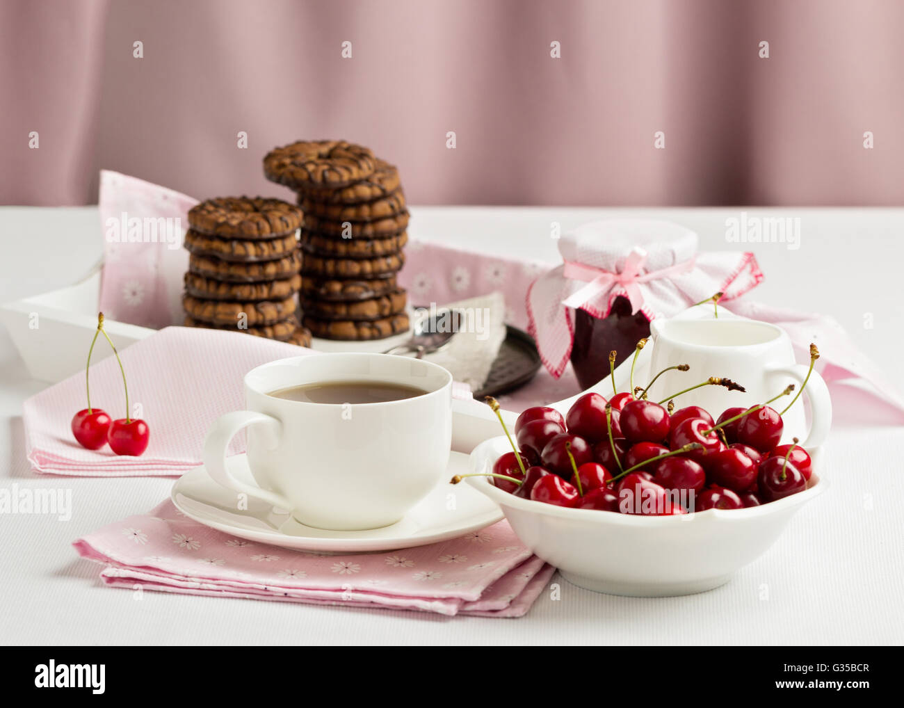 Breakfast. Tea with chocolate chip cookies on a white tray. Selective ...