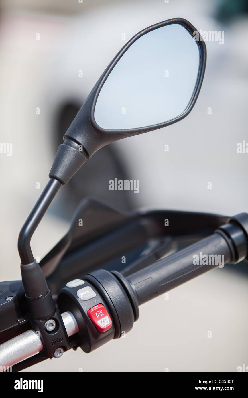 Color image with the controls on a motorcycle handlebar and a mirror ...