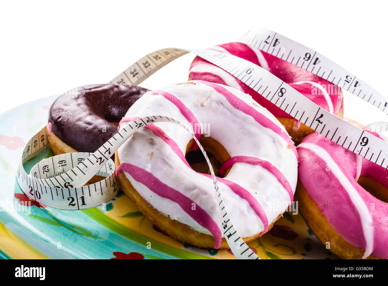 some delicious and colorful donuts with measuring tape Stock Photo - Alamy