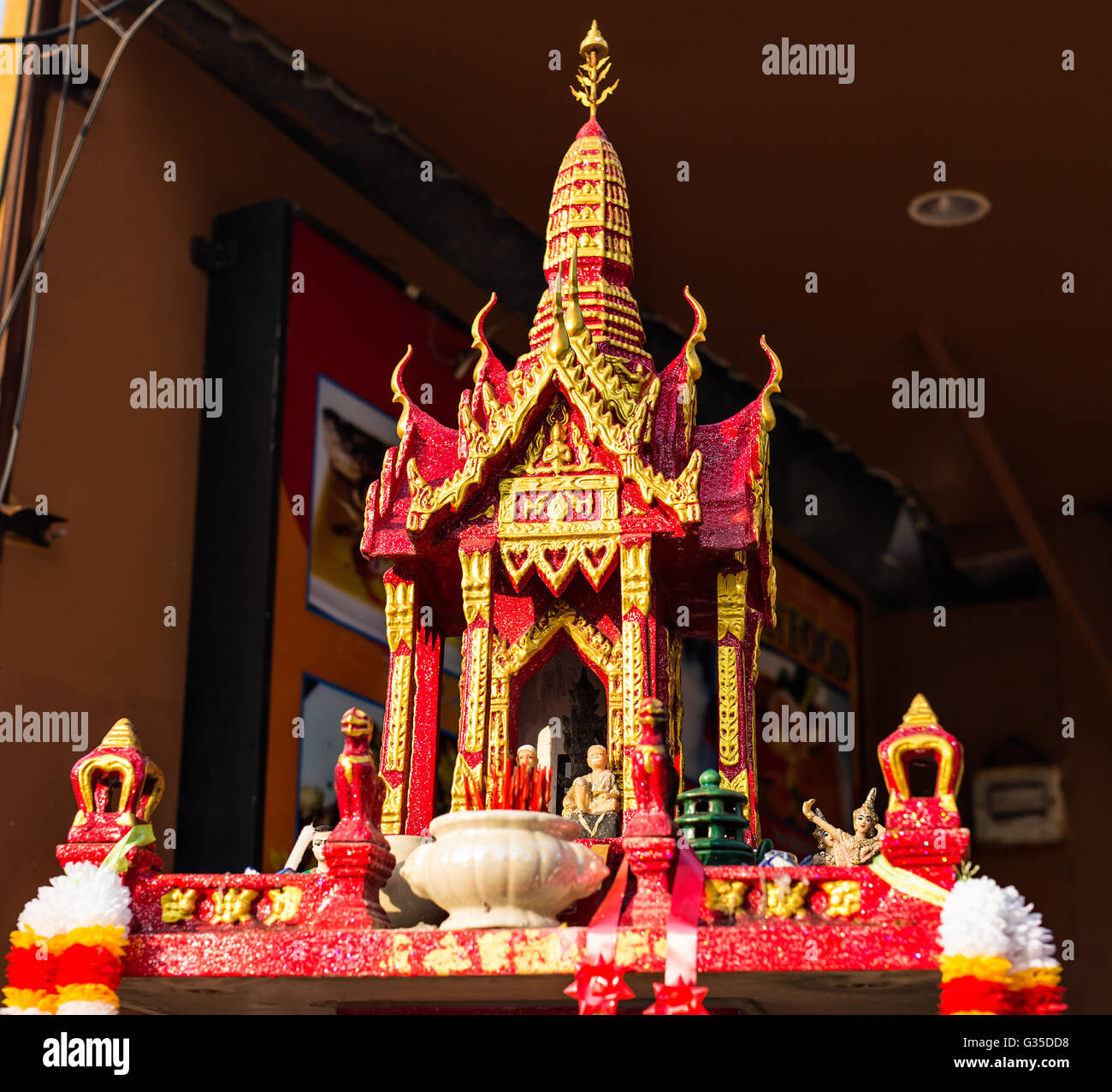 Outdoor spirit house in Thailand. garland and some wreathes, joss house ...